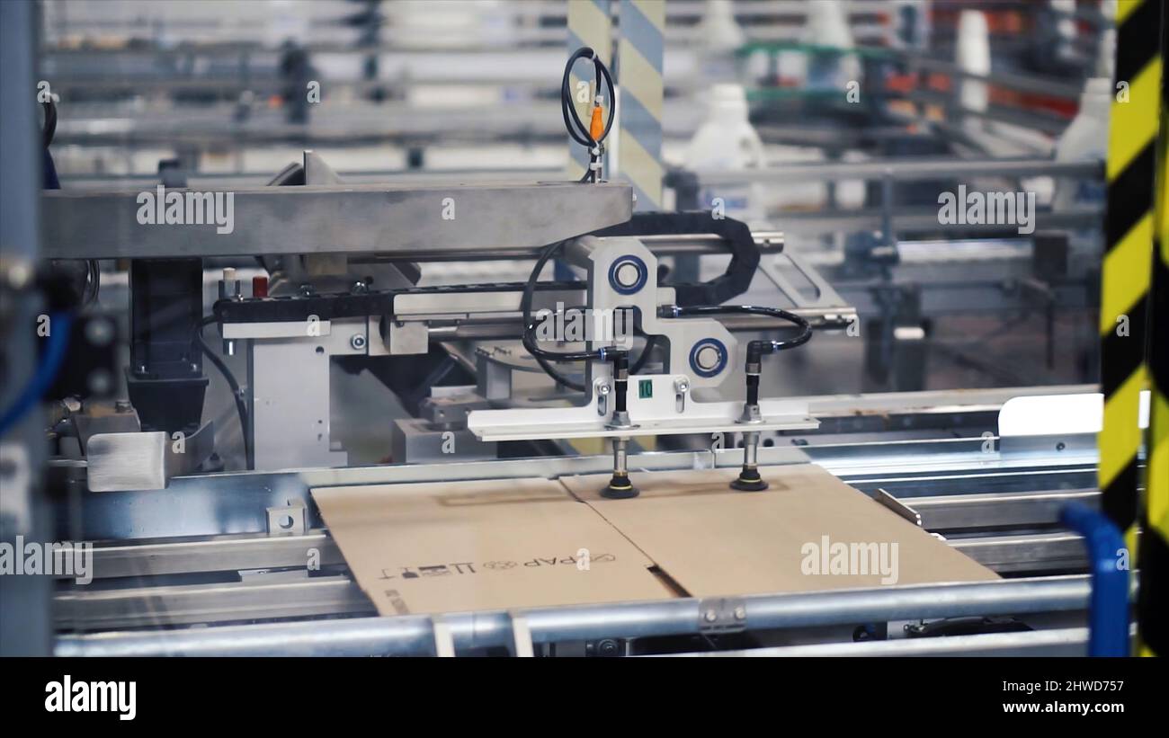 Cardboard package box packing machine. Clip. Box forming production ...