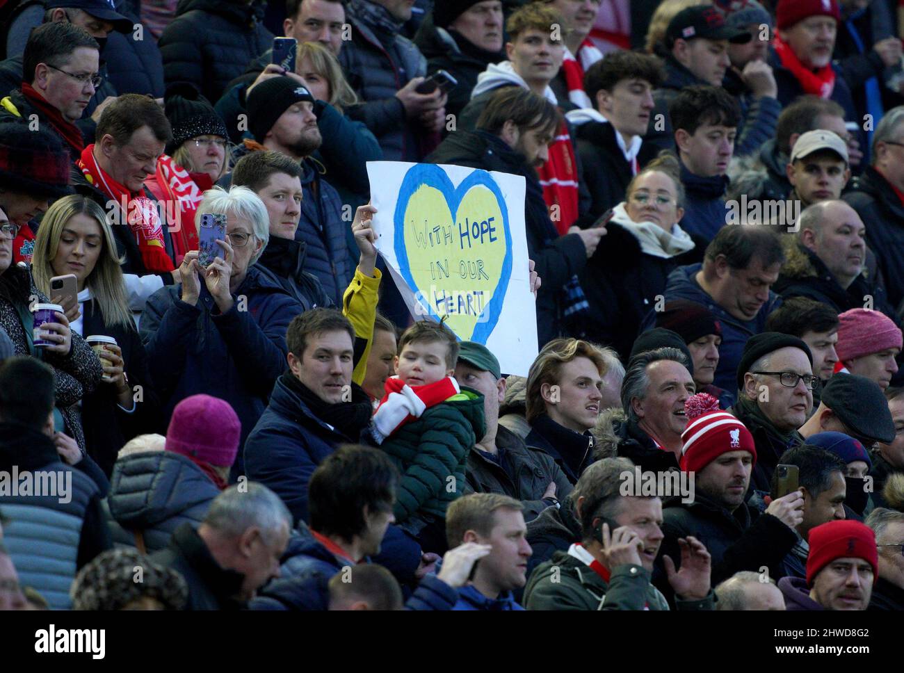 Liverpool fans hold a sign in support of Ukraine, in the stands before ...