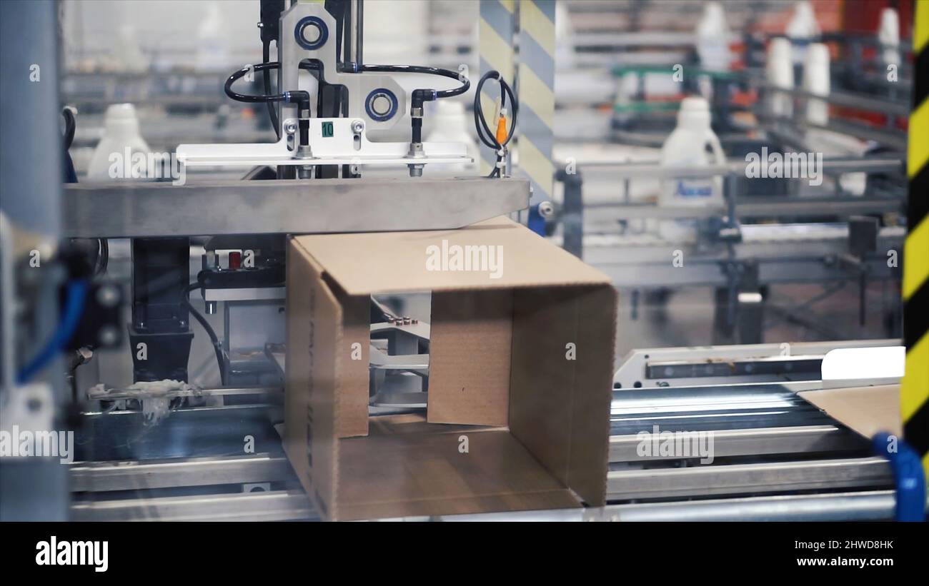 Cardboard package box packing machine. Clip. Box forming production ...