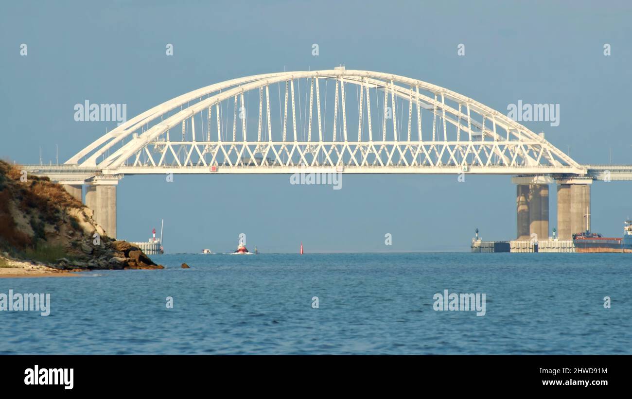 View of the beautiful large white bridge for cars moving above the calm ...