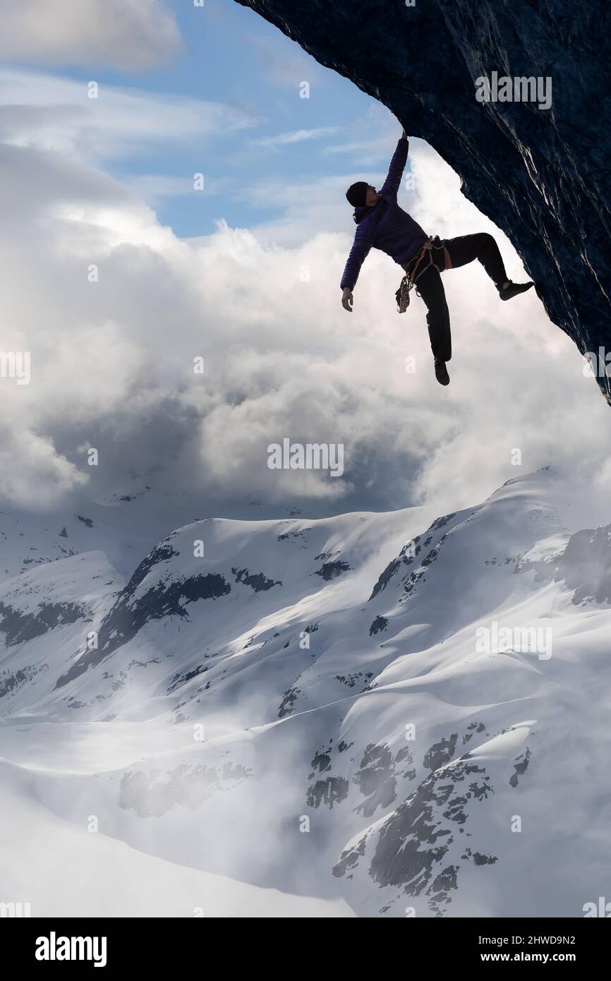 Adult adventurous man Rock Climbing a steep rocky cliff Stock Photo - Alamy