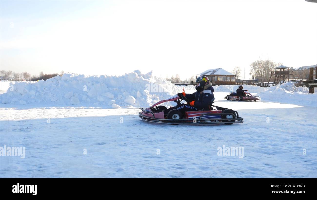 Kart racing on the frozen lake. Winter cart. Riding a go kart in the ...