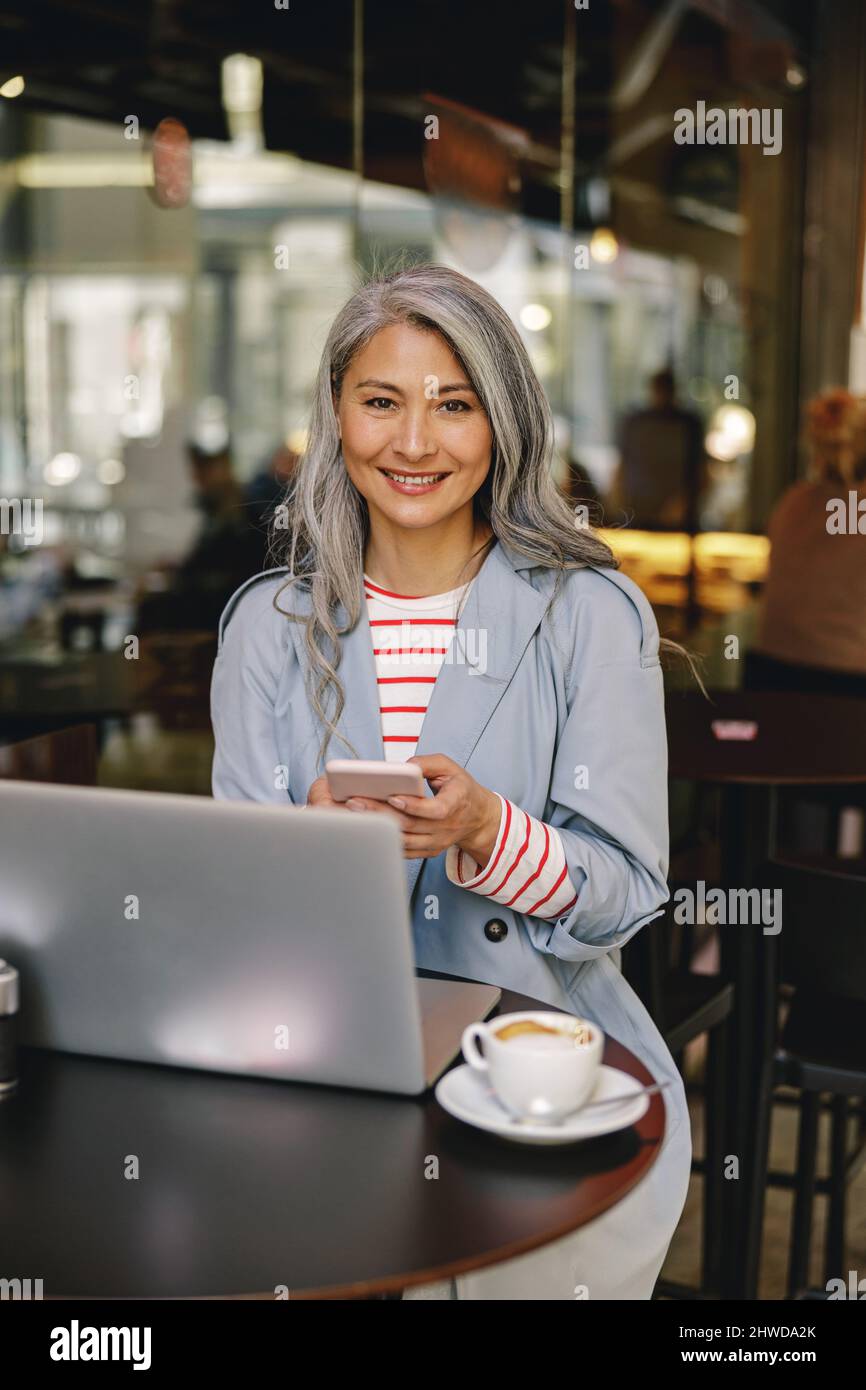 Confident female with happy face posing indoors Stock Photo - Alamy