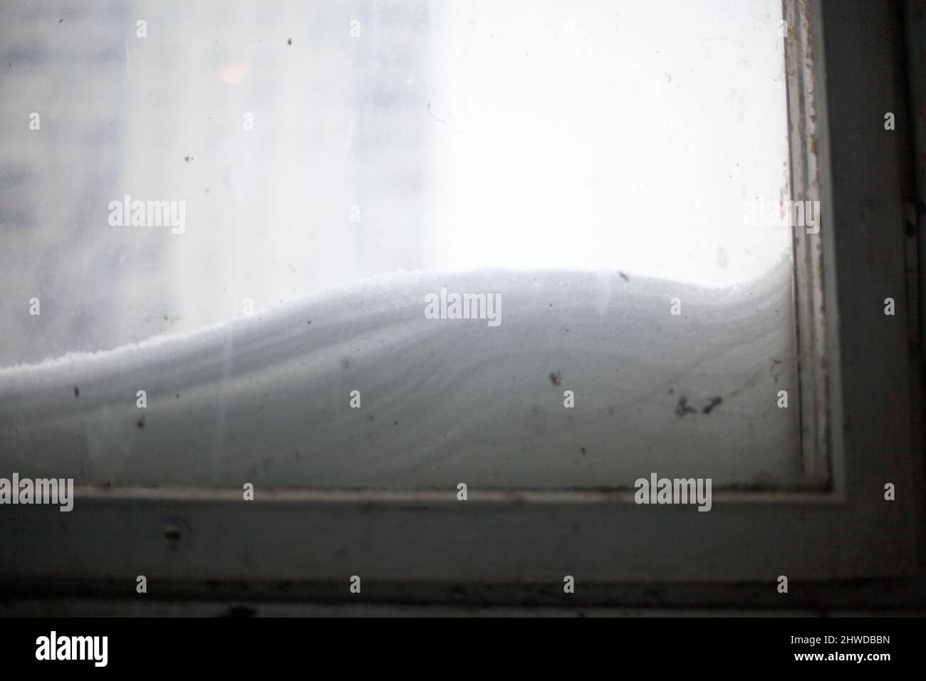 Snow on window. Cold weather. Frozen window. Old window frame. Entrance ...