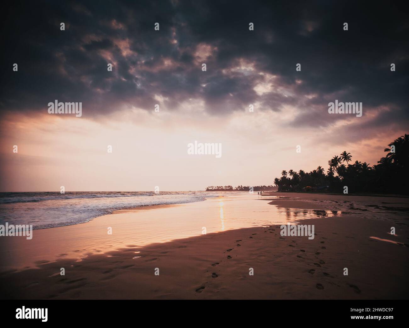 beautiful sunset over tropical beach Stock Photo - Alamy