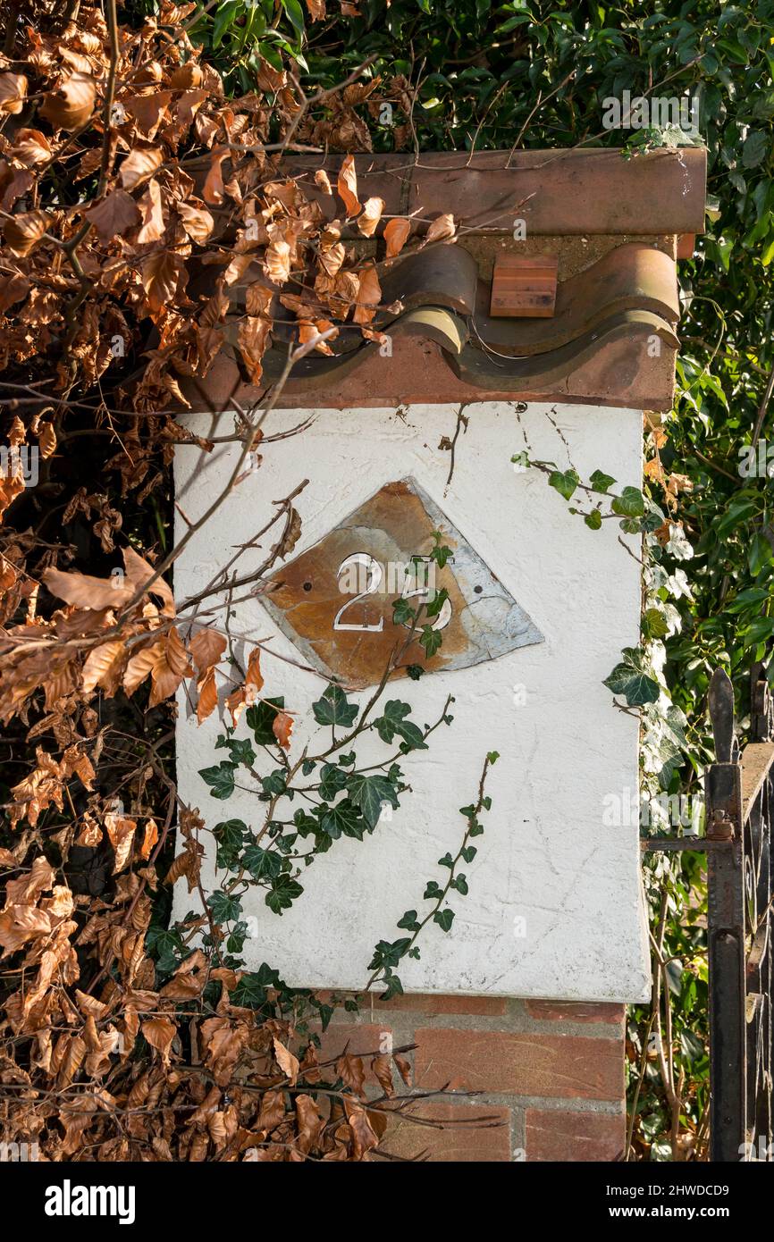 House number on brick gatepost covered with ivy Stock Photo - Alamy