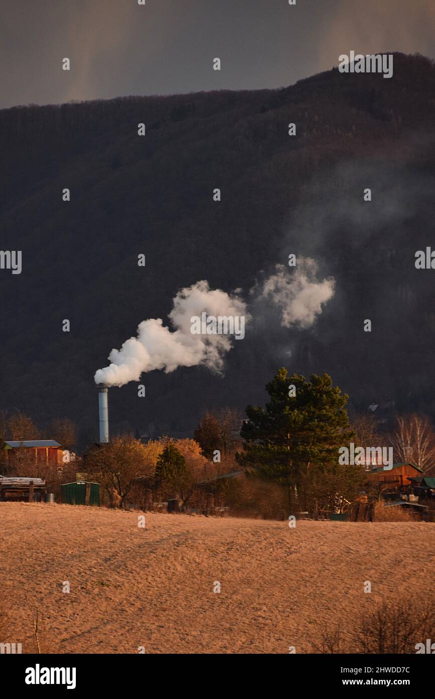 factory smoking chimney in nature Stock Photo - Alamy