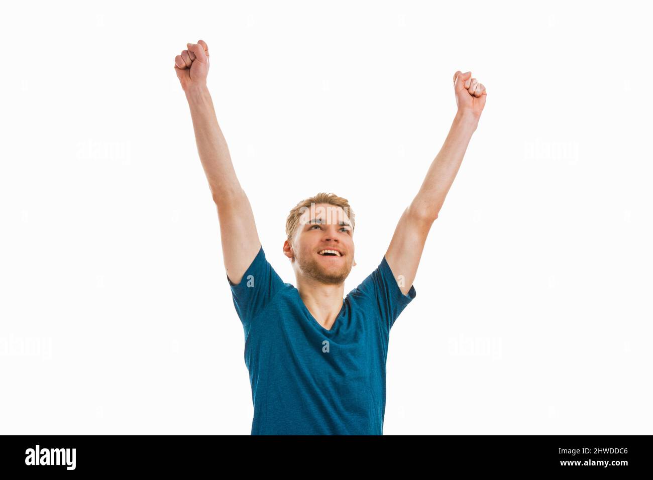 Happy young man with both arms up, isolated on white background Stock ...