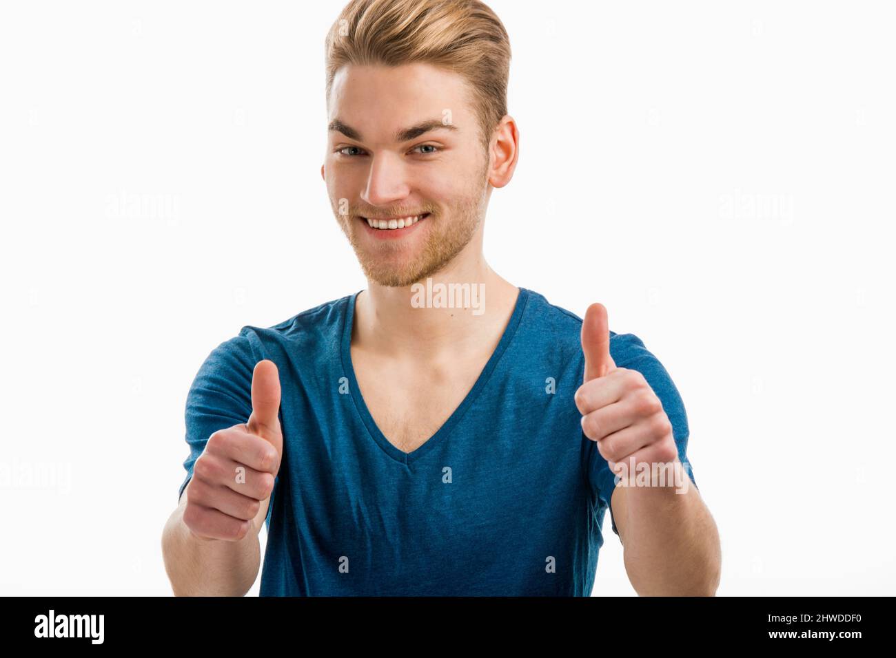 Good looking young man with a smiley face and thumbs up, isolated on ...