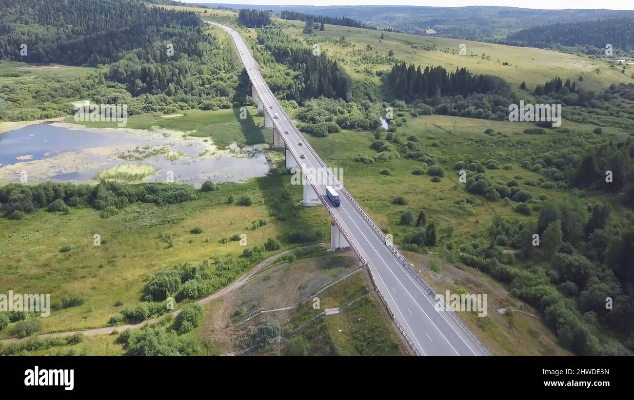 Aerial view of highway with trees and mountain. Clip. Top view of the ...