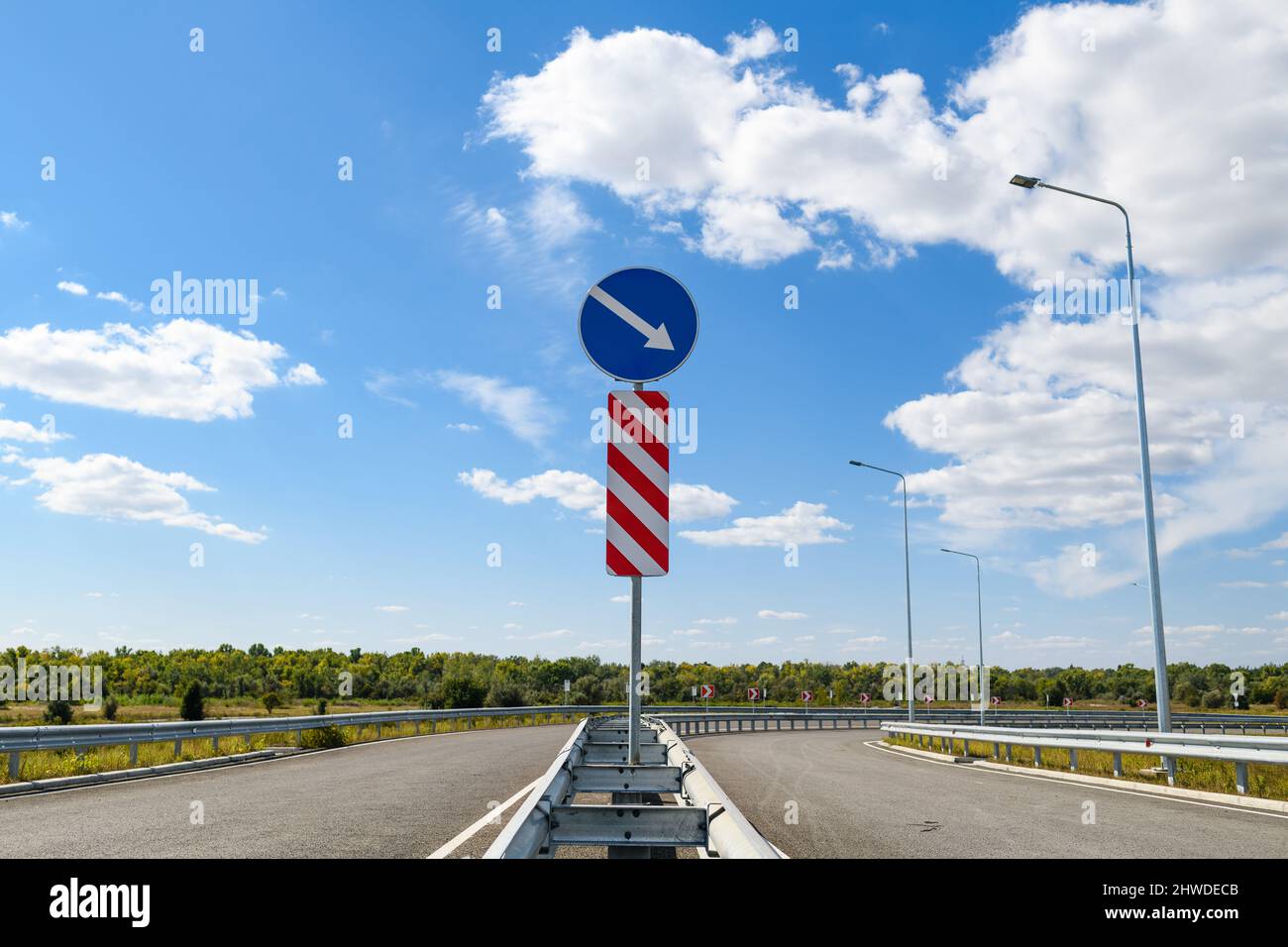 Separation barrier and direction sign detour on the right. Warning ...