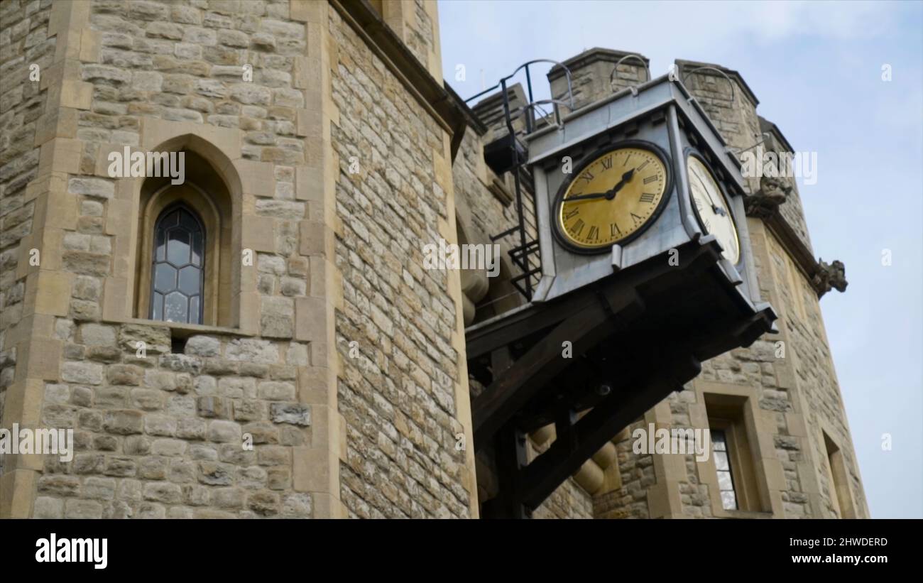 Close-up of old street clock on stone wall of building. Action. Street ...