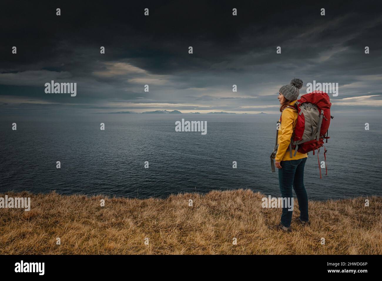 Female backpacker traveller in Iceland watching the Ocean Stock Photo ...