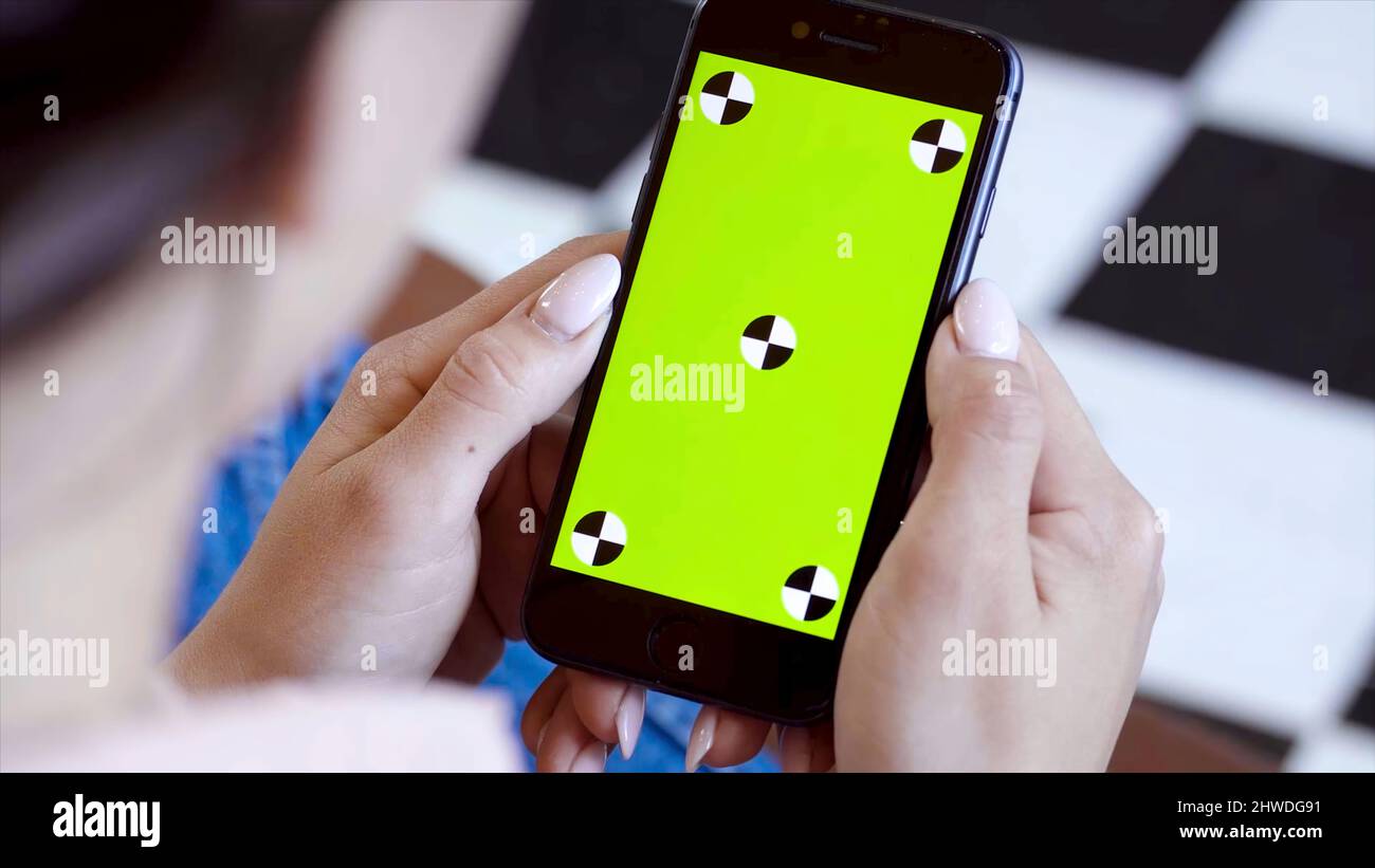 Close-up of woman looking into phone with green screen. Stock footage ...