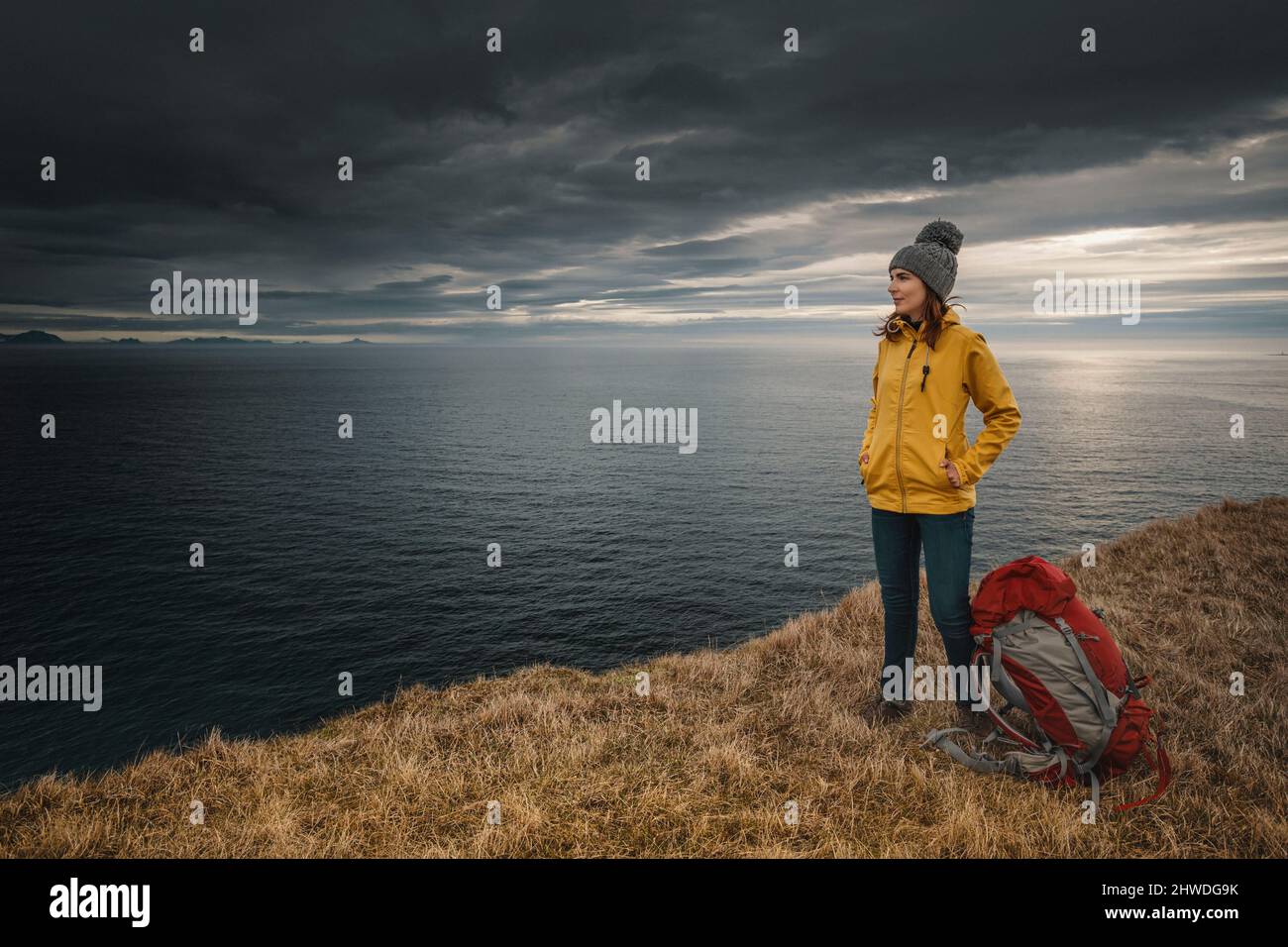 Female backpacker traveller in Iceland watching the Ocean Stock Photo ...