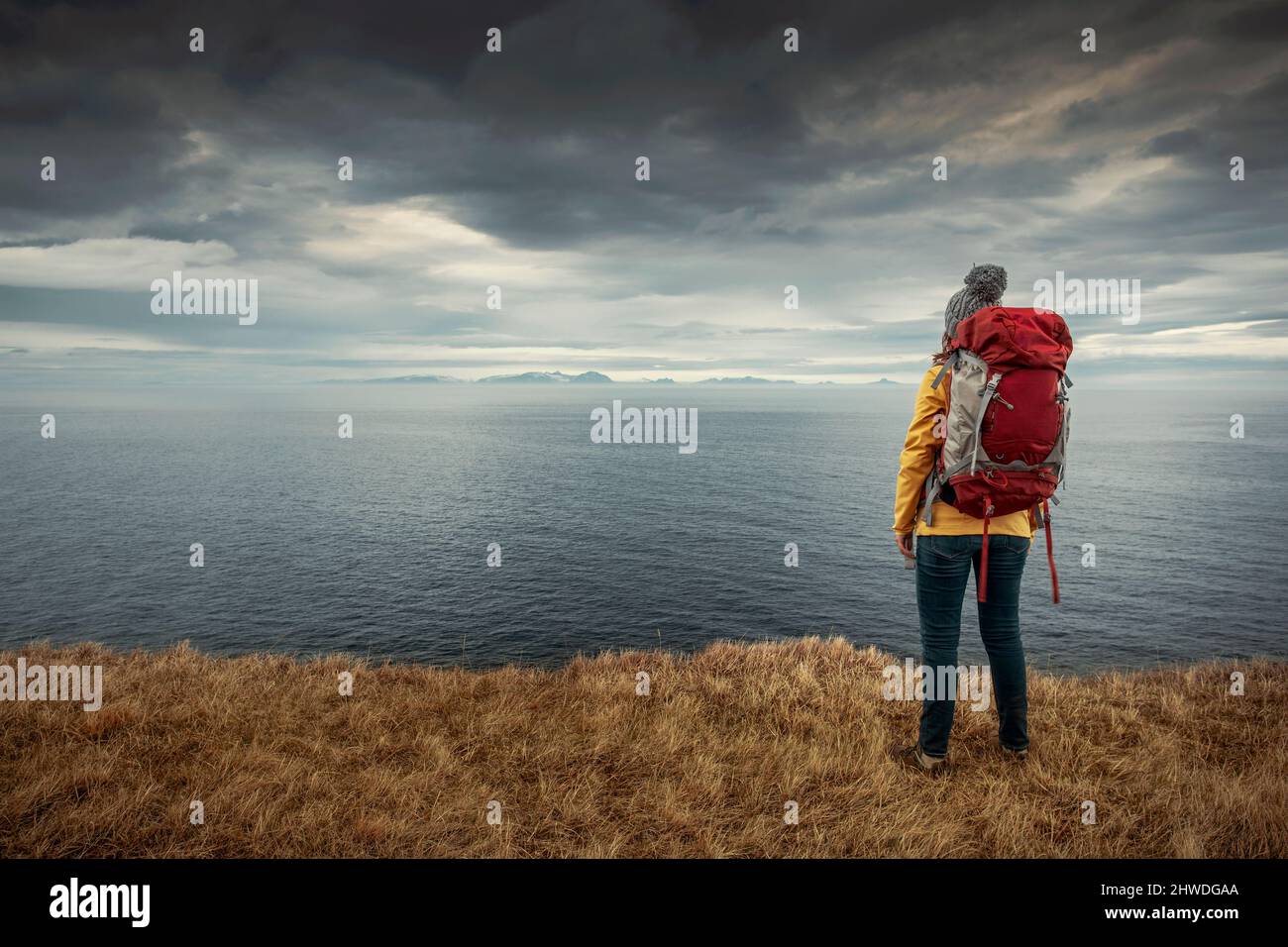 Female backpacker traveller in Iceland watching the Ocean Stock Photo ...