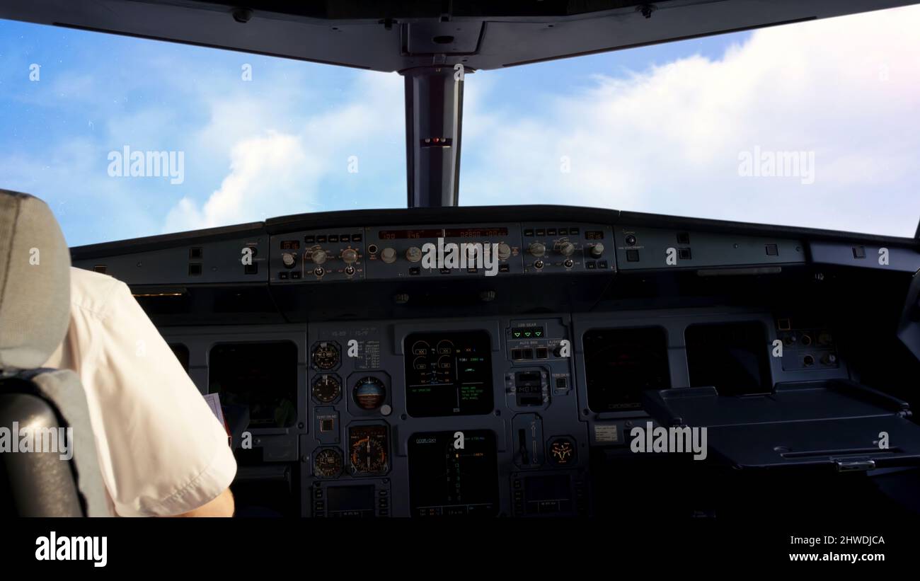 In cockpit, airplane flying over the clouds. View from the cockpit in ...