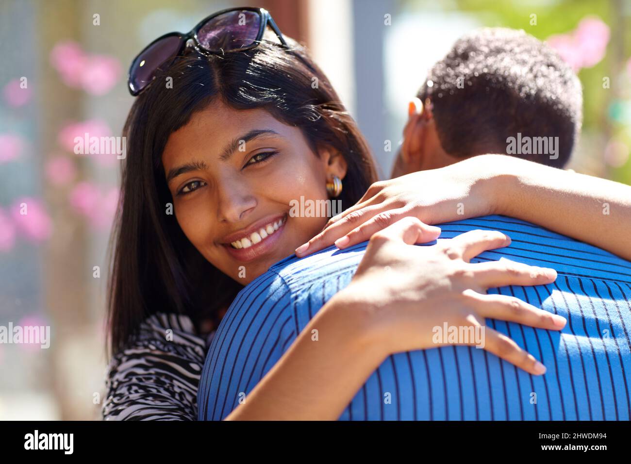 Hes my one and only. Portrait of a beautiful young woman hugging her boyfriend outdoors Stock ...