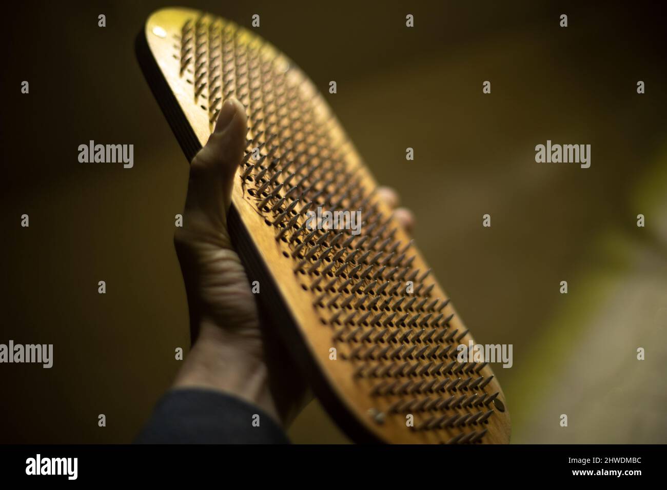 Board with nails. Tool for practicing yoga. Small nails stick out of ...