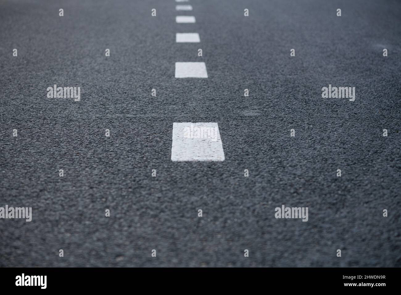 Empty road with the white traffic lines, close-up Stock Photo - Alamy