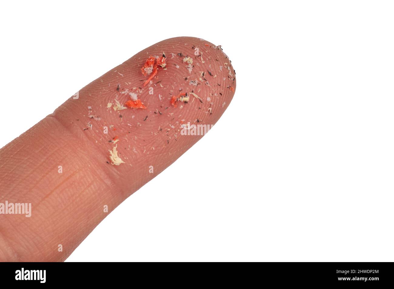 Micro plastic. Small plastic pellets on the finger. Close-up of ...