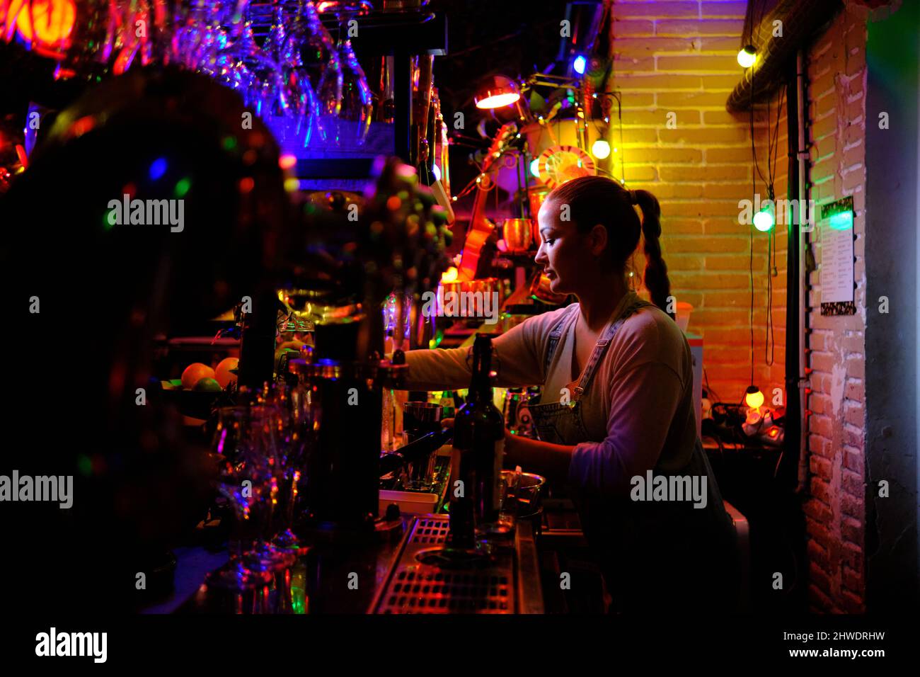 Female bartender working behind the counter of a bar Stock Photo - Alamy