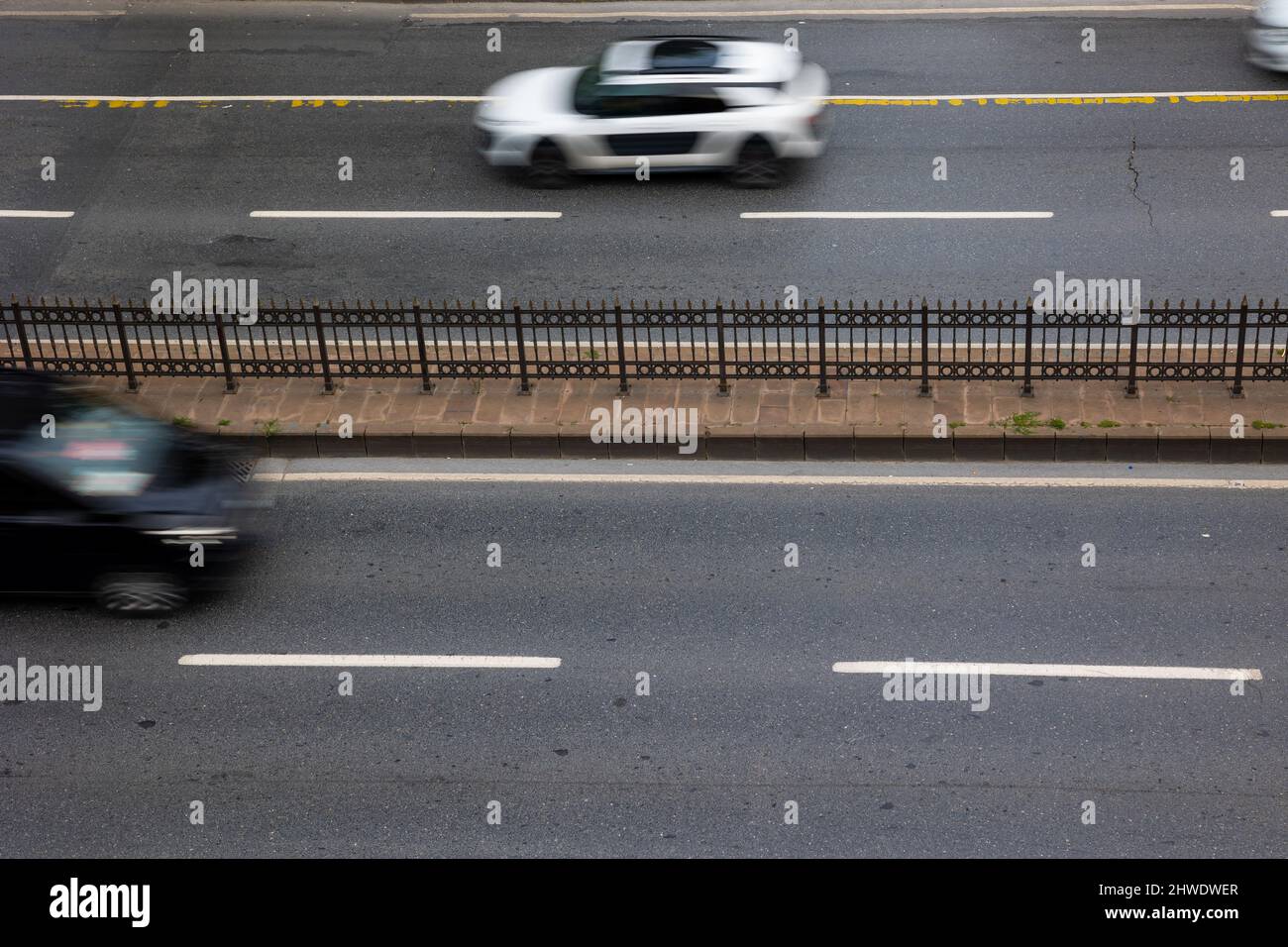 City road. Top view of two lanes road with motion blurred cars. Traffic ...