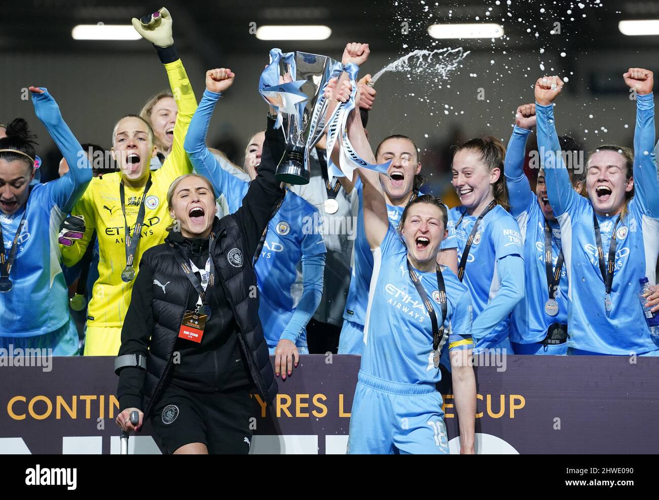 Manchester City's Ellen White (centre right) lifts the trophy following ...