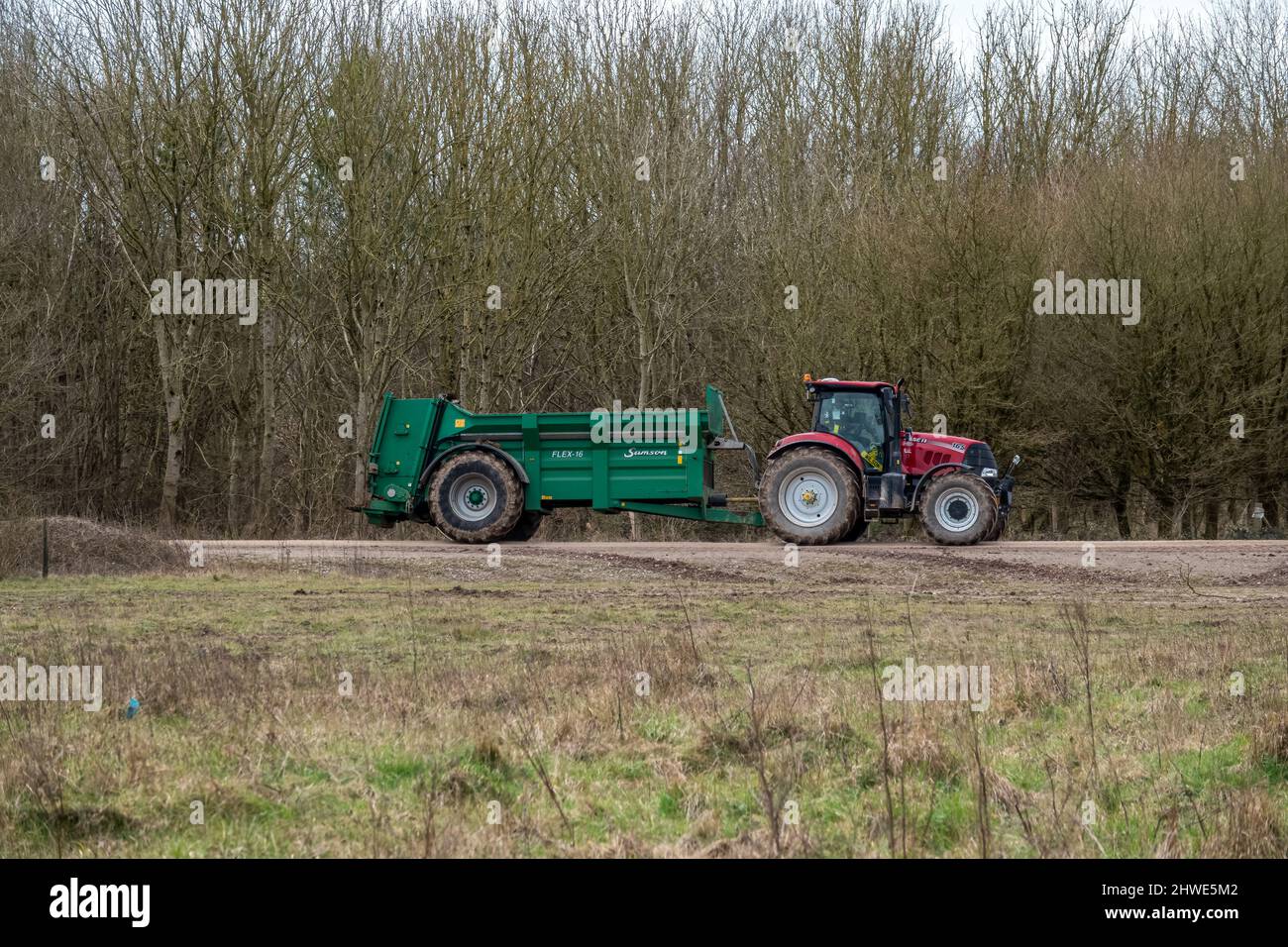 Red Case Puma 340 red tractor towing a Samson Flex-16 green muck ...