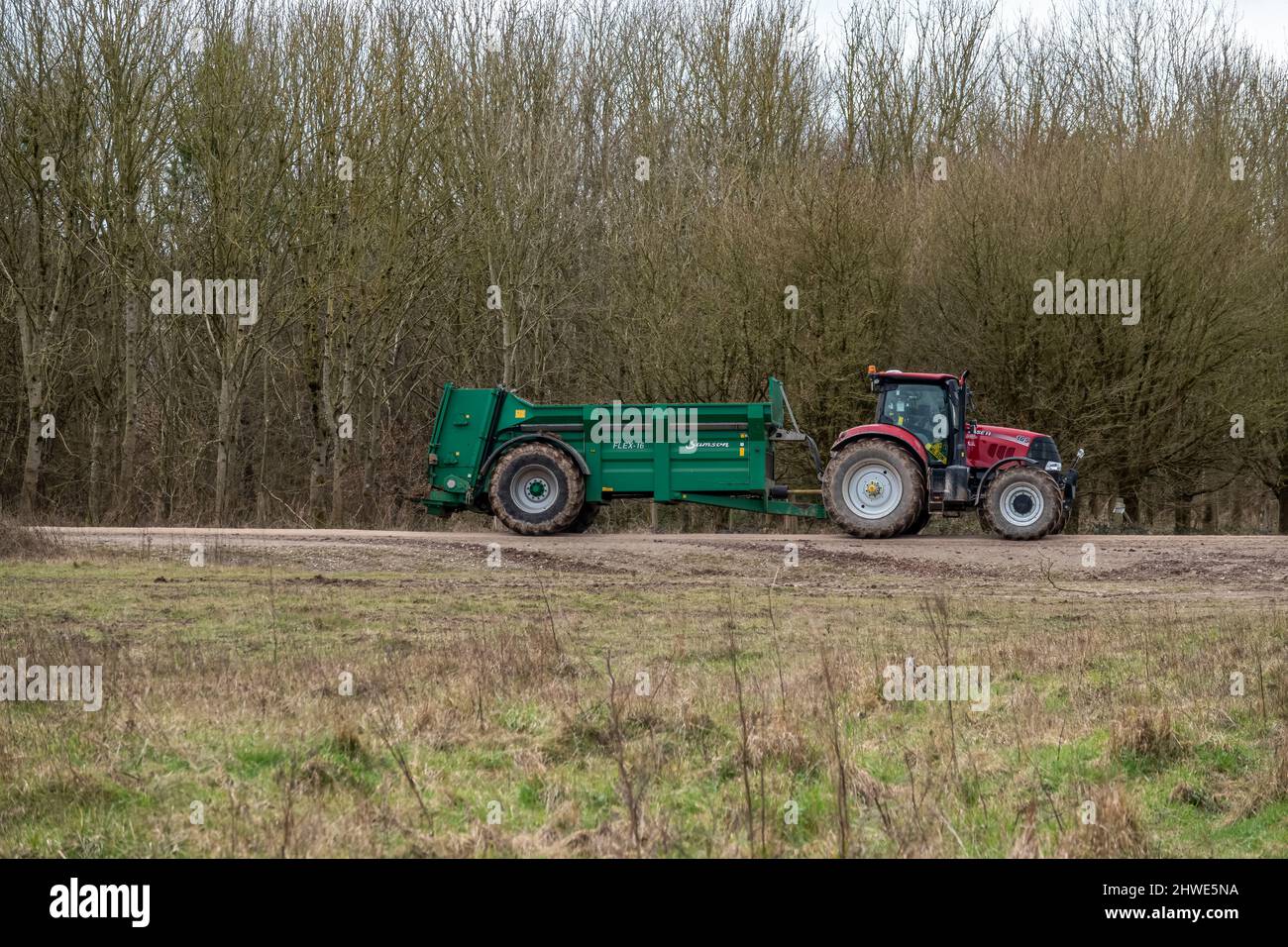 Red Case Puma 340 red tractor towing a Samson Flex-16 green muck ...