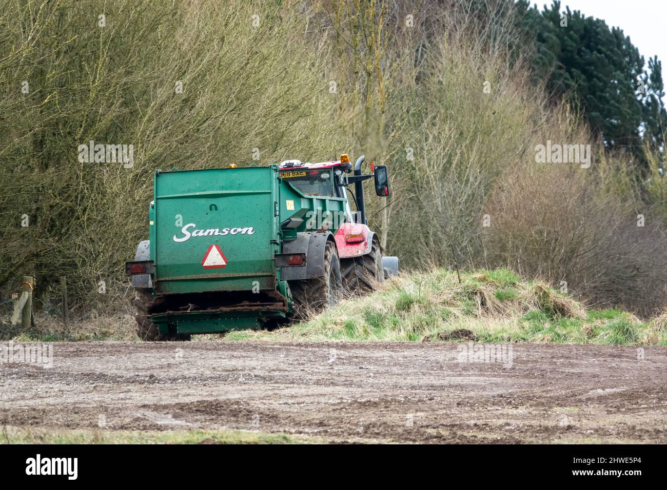 Red Case Puma 340 red tractor towing a Samson Flex-16 green muck ...