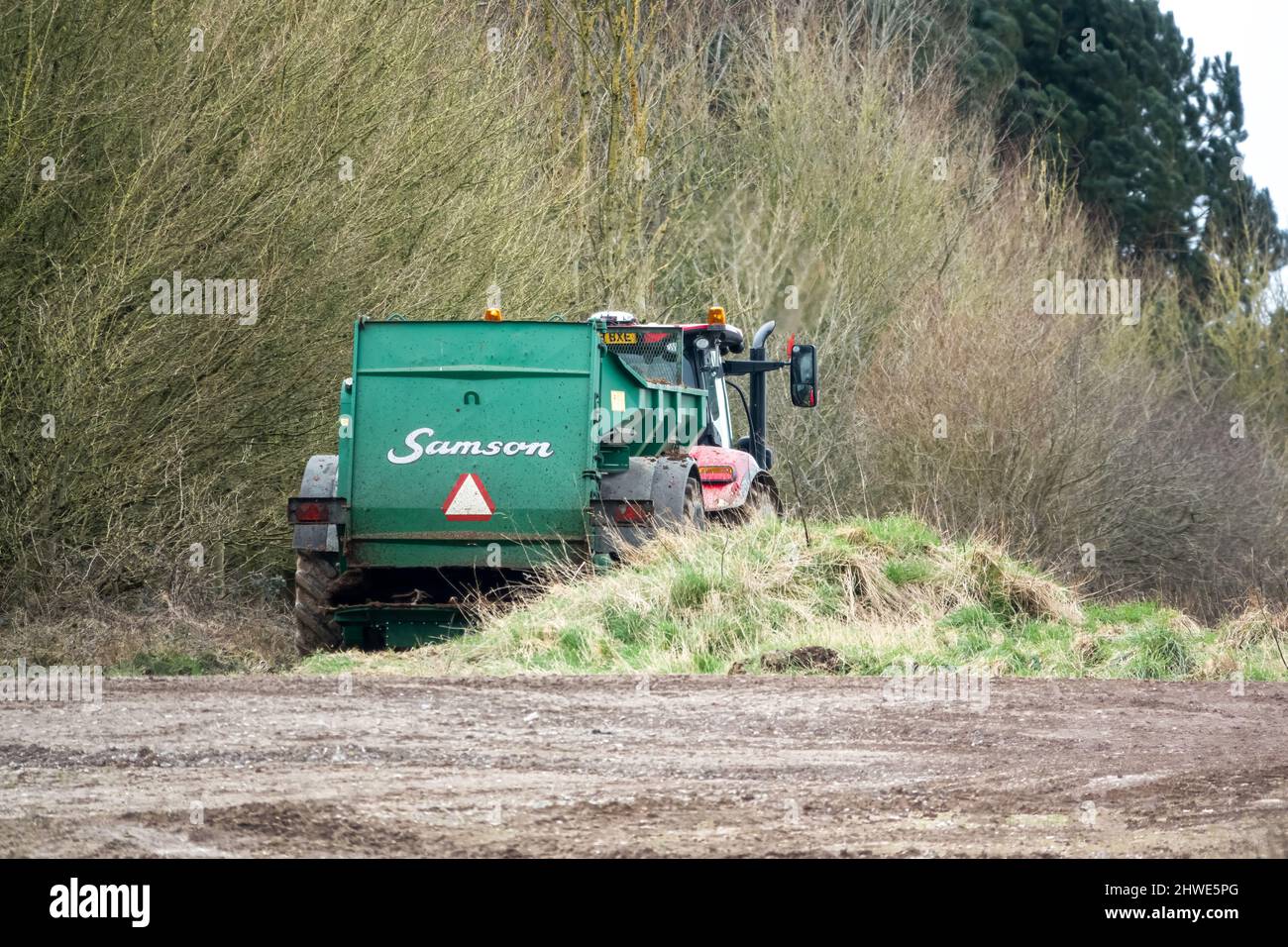 Red Case Puma 340 red tractor towing a Samson Flex-16 green muck ...