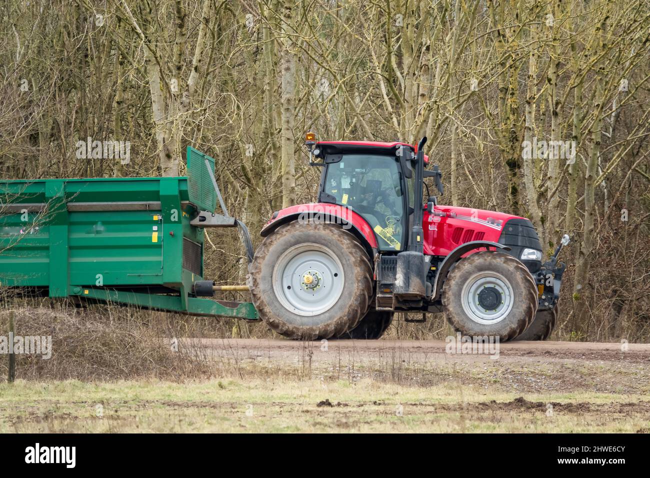 Red Case Puma 340 red tractor towing a Samson Flex-16 green muck ...
