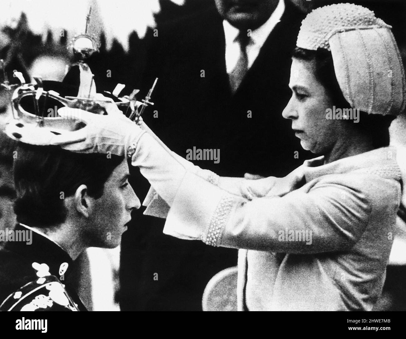 HRH Queen Elizabeth II places the crown on the head of Prince Charles ...