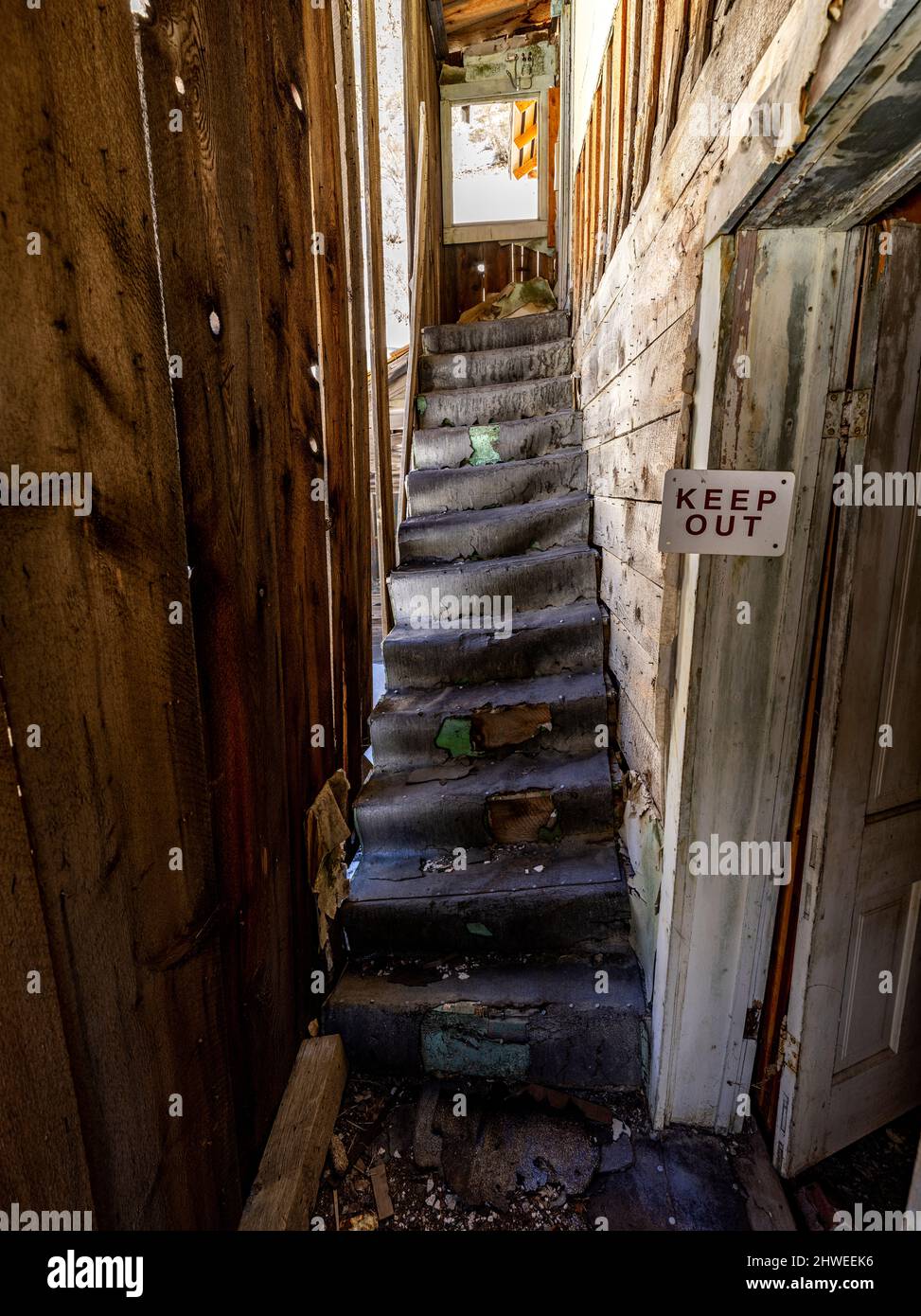 Keep out sign on a rickety flight of stairs in an abandon buildings ...