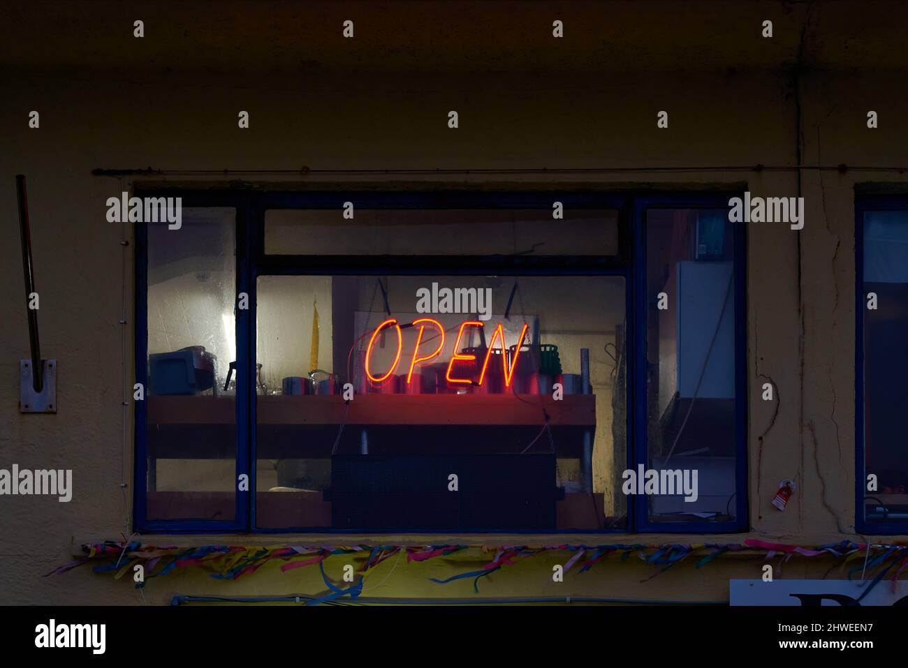 A neon red open sign in a dark shop window Stock Photo - Alamy