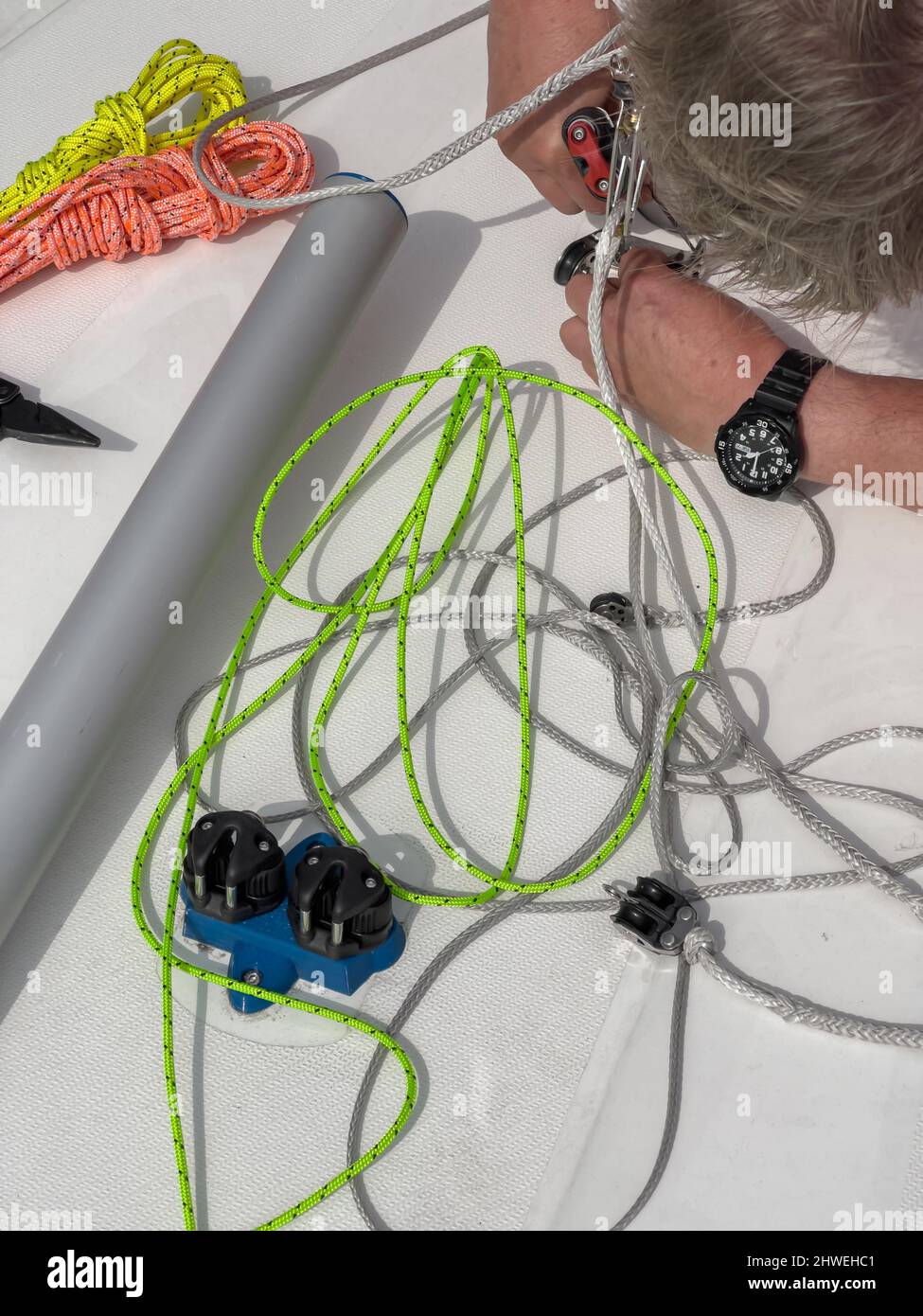 Close-up view of a sailor sets up a sports boat, set of ship equipment ...