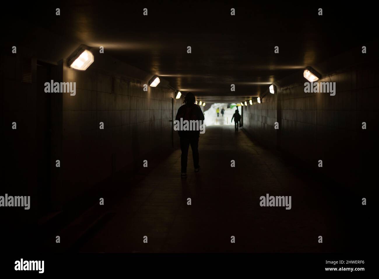 Guy in tunnel. Man walks underground. Urban architecture. Underground ...