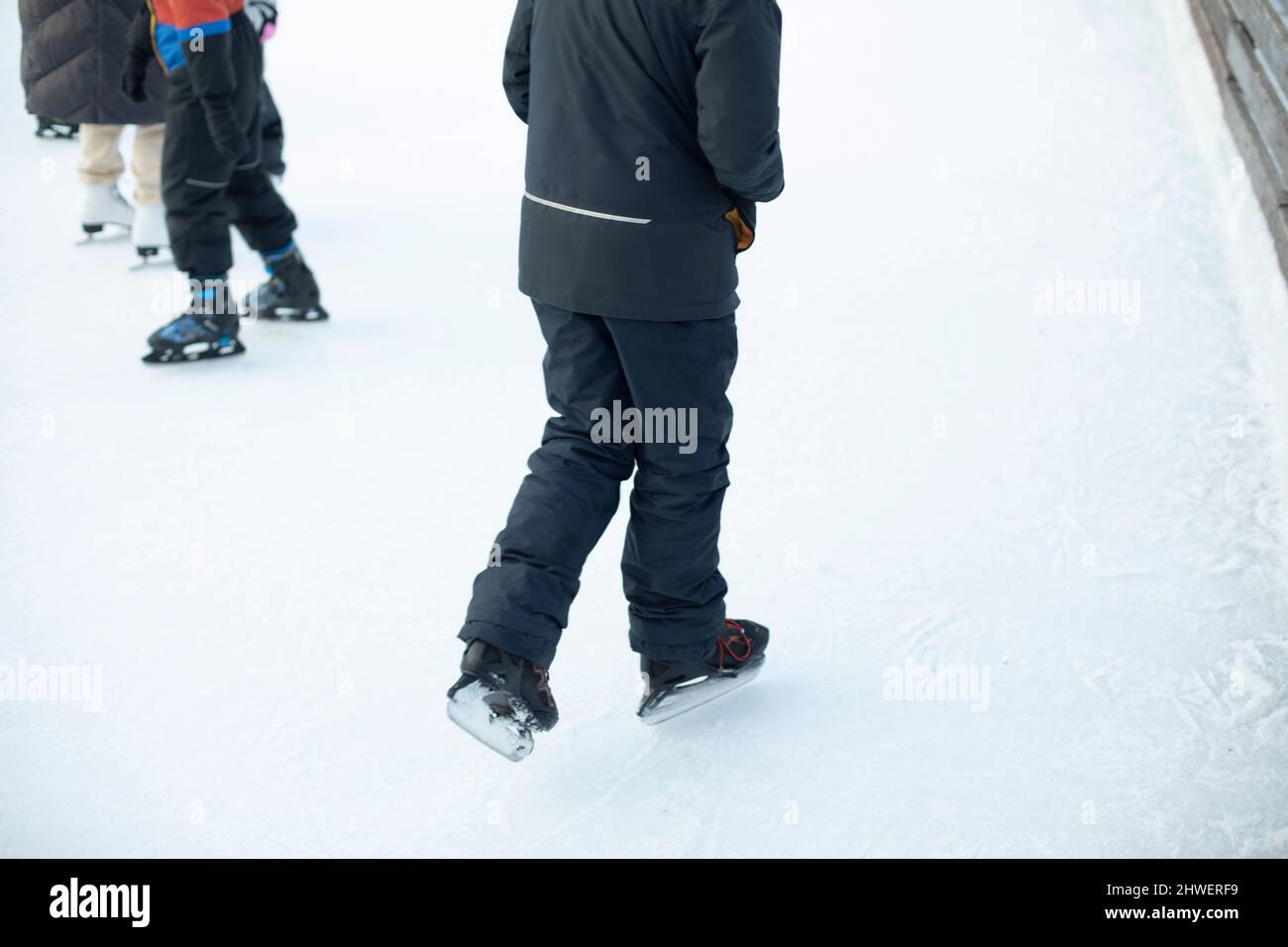 Ice skating in winter. People at rink. Rest in winter in park. People ...