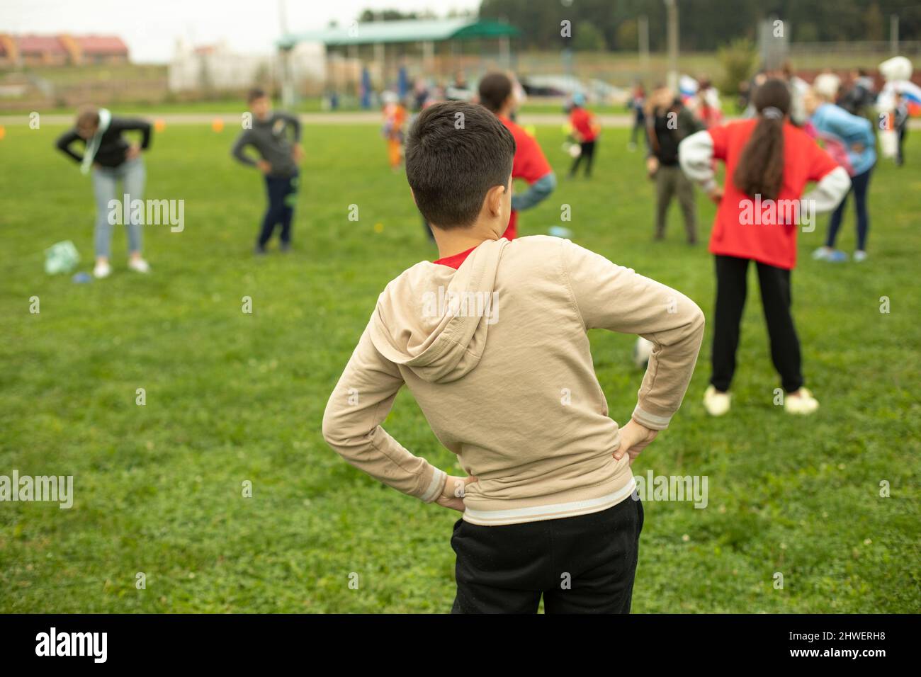 Schoolboy does gymnastics in park. Sports activity for children. Health ...