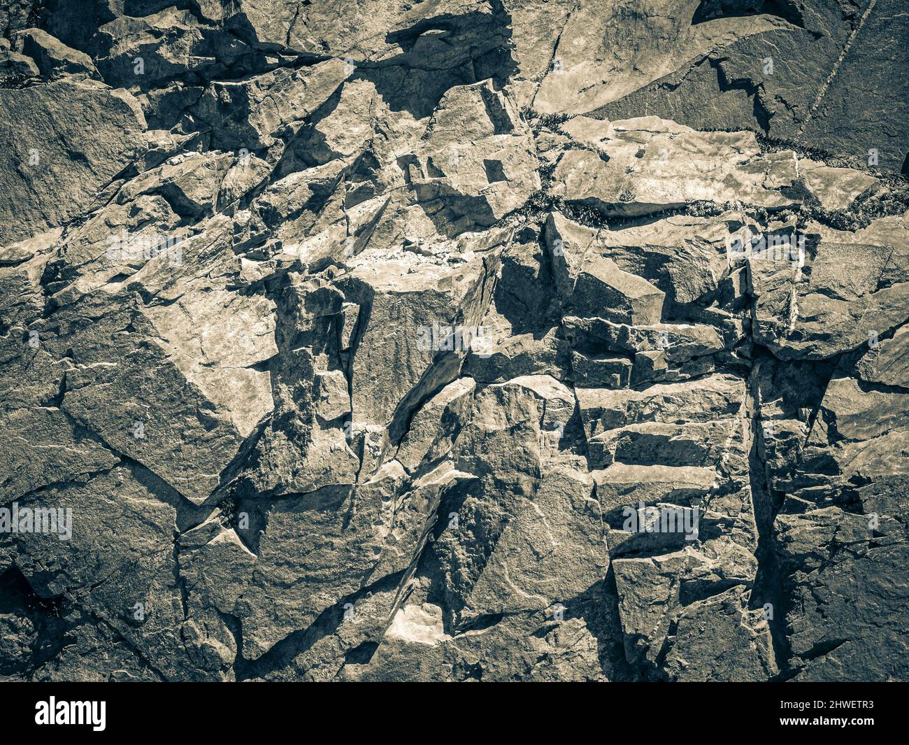 Old black and white picture of a stone rock wall texture with orange ...