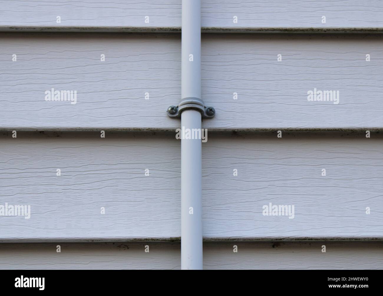 A White Pipe Attached to the Exterior Siding of a Home Stock Photo - Alamy