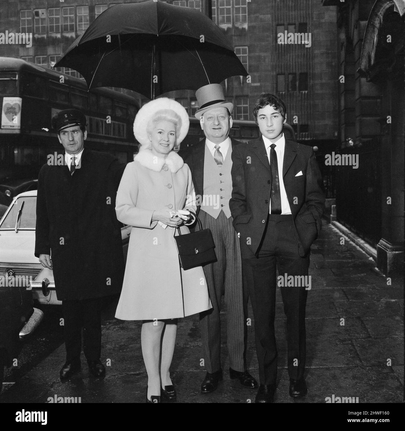 Media Mogul Lew Grade, stands underneath an umbrella with his wife Lady ...