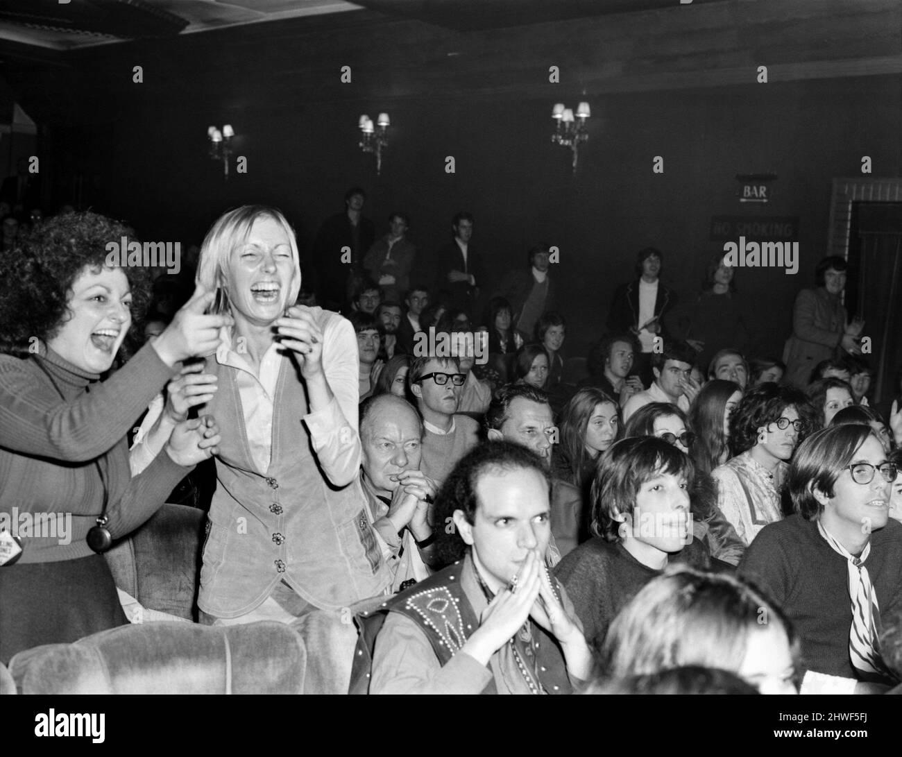 Rolling Stones Pop Concert: Two girls swinging in their seat at the ...