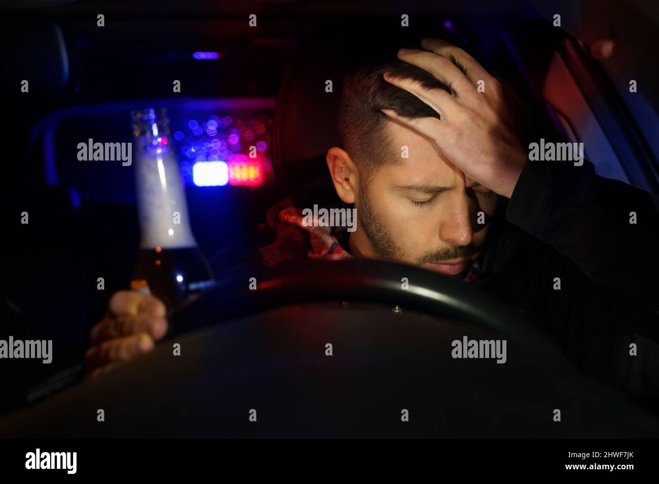 Road police with flashing lights stopped drunk driver. Young man ...