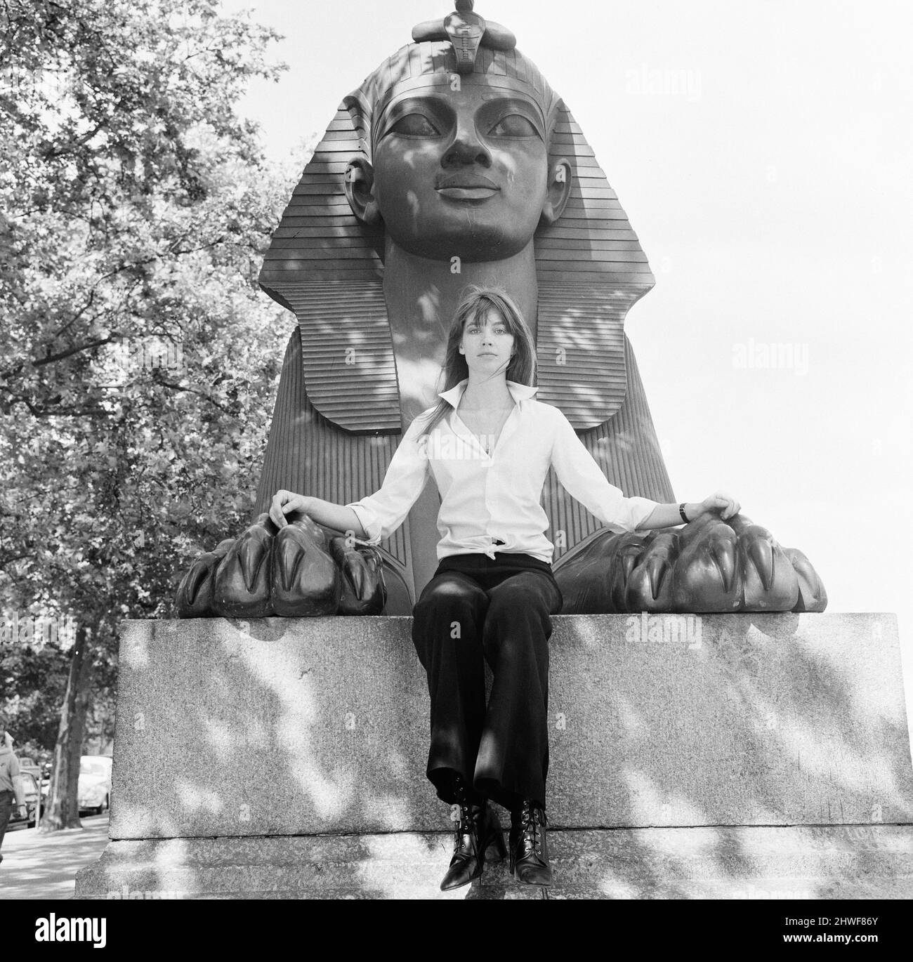 Francoise Hardy, french singer pictured seated between the feet of a ...
