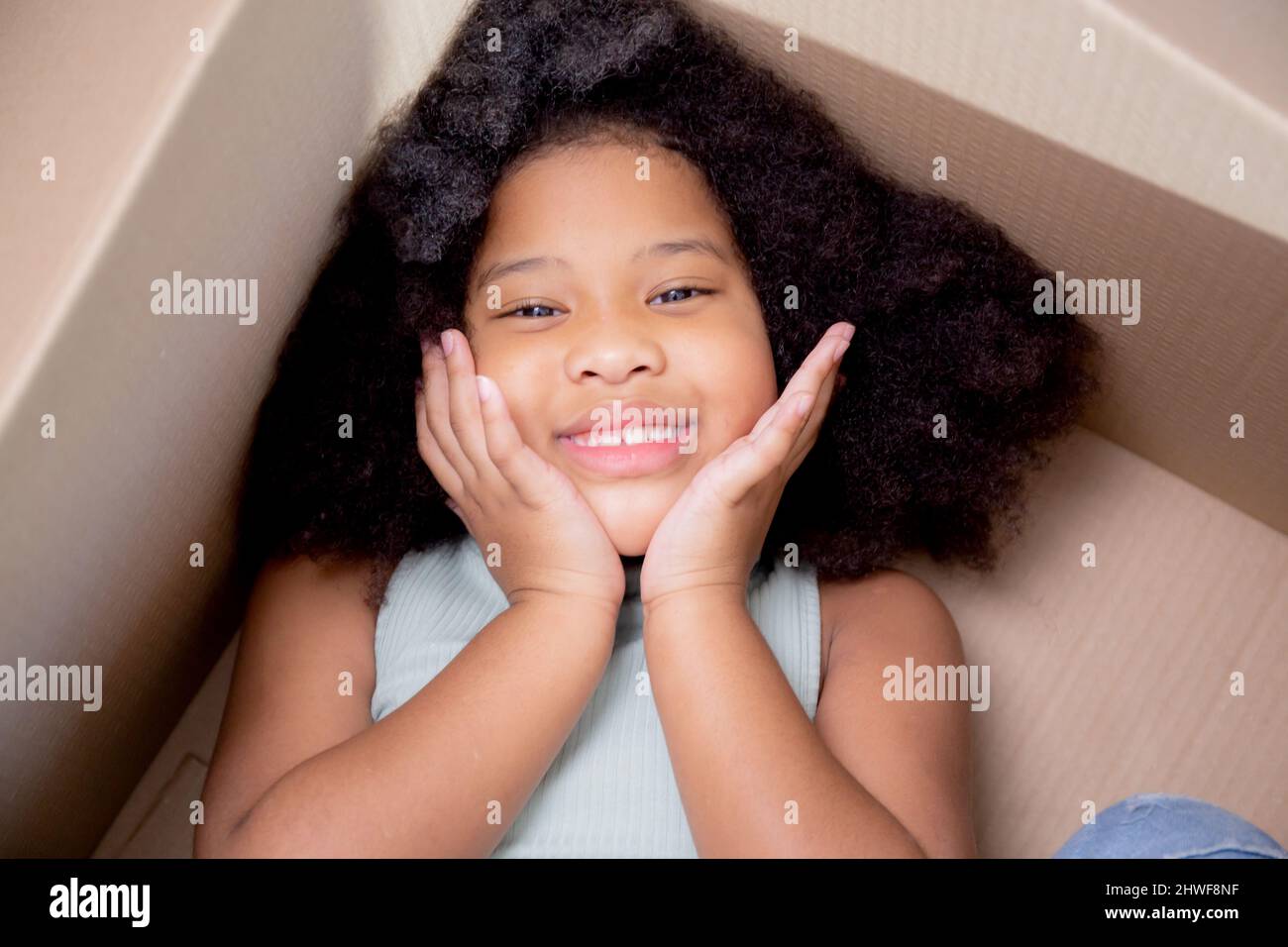 Happiness African children hiding inside box with playful and ...