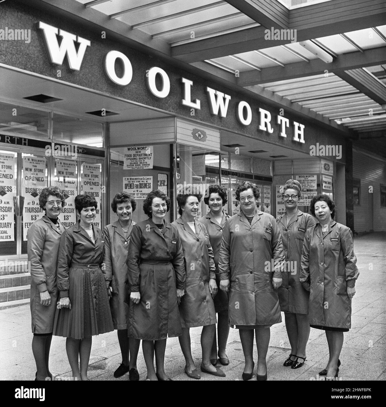 Shop assistants pose outside the New Woolworth store, East Kilbride ...