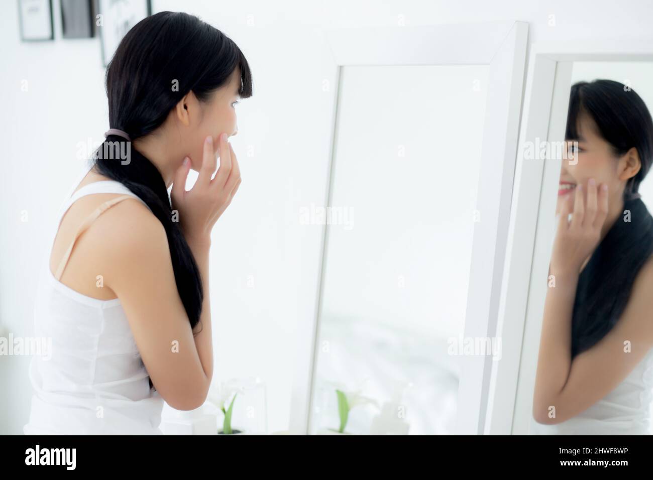 Beautiful face of young asian woman with happy smiling and touch cheek ...
