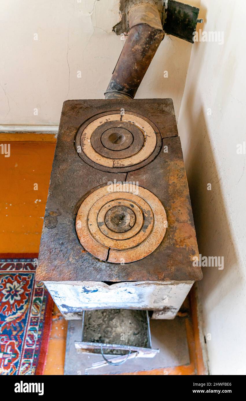 Old rusty oven heat by fire, with two round cooking places Stock Photo ...